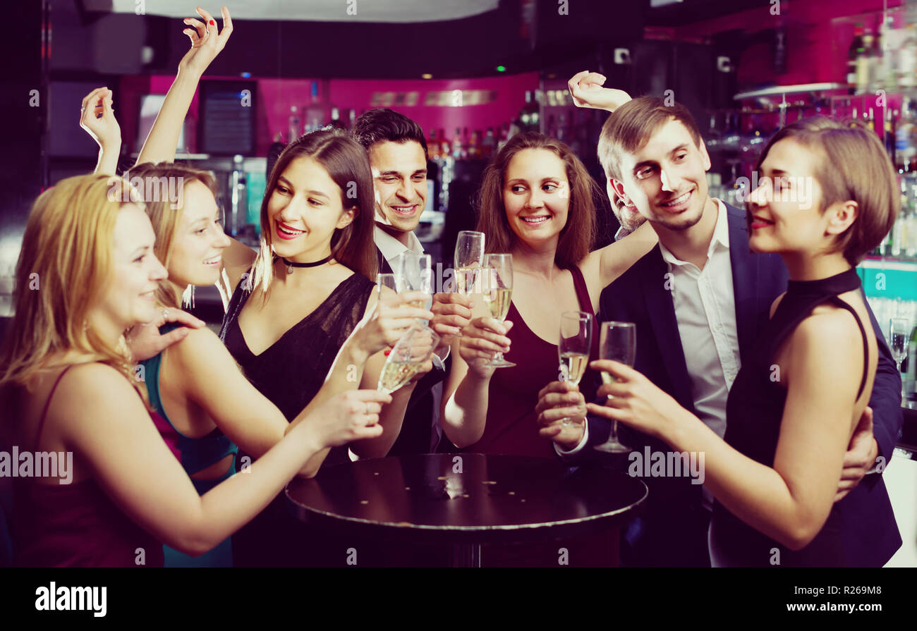 Laughing colleagues dancing on corporate party with cocktails Stock ...