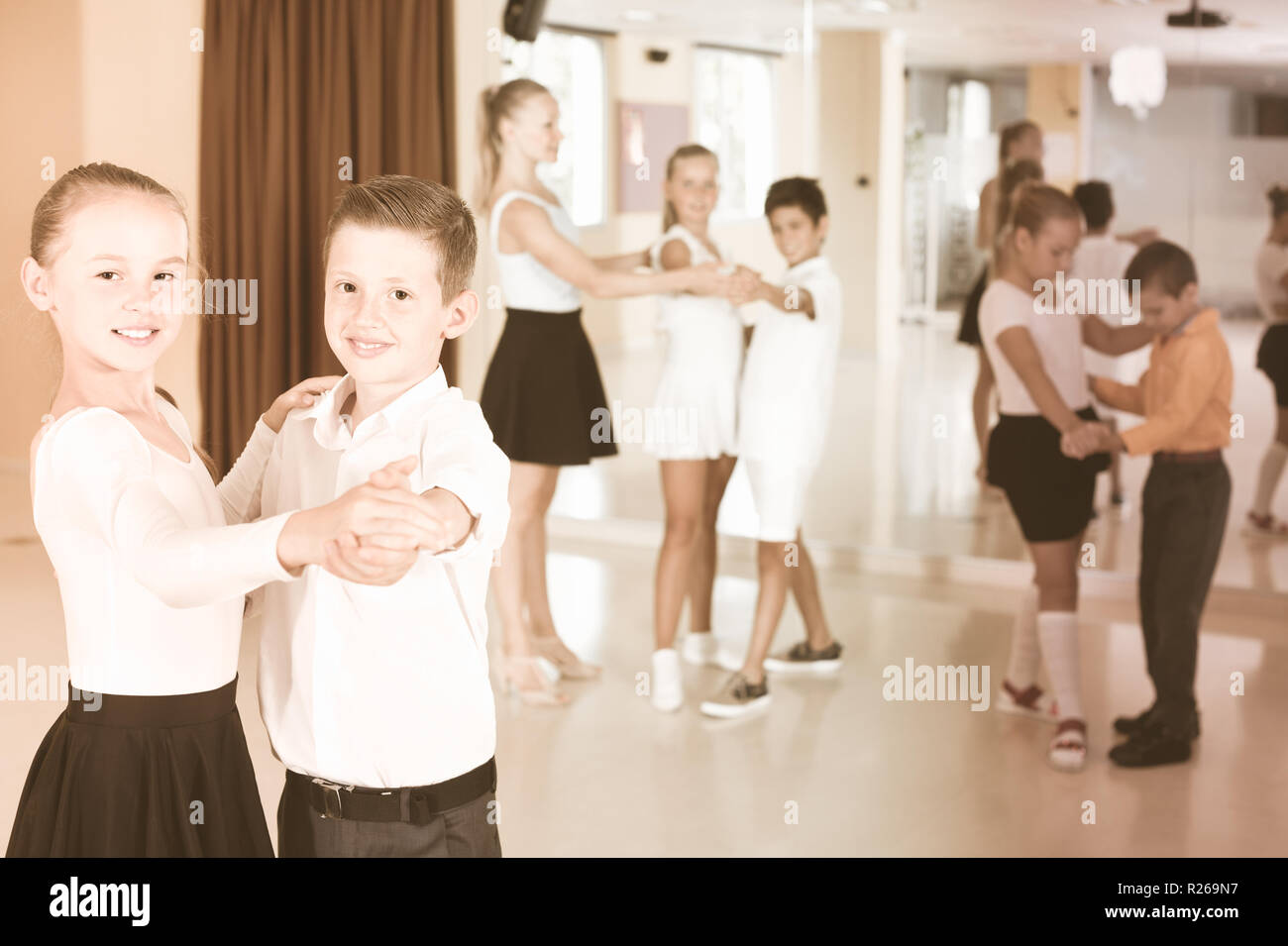 Group of friendly positive children dancing tango in dance studio Stock ...