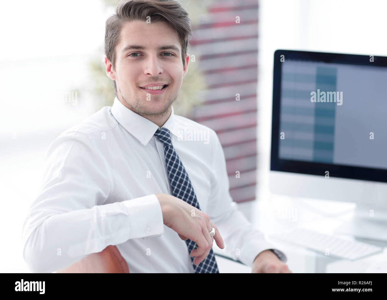 employee sitting in front of a computer screen Stock Photo - Alamy