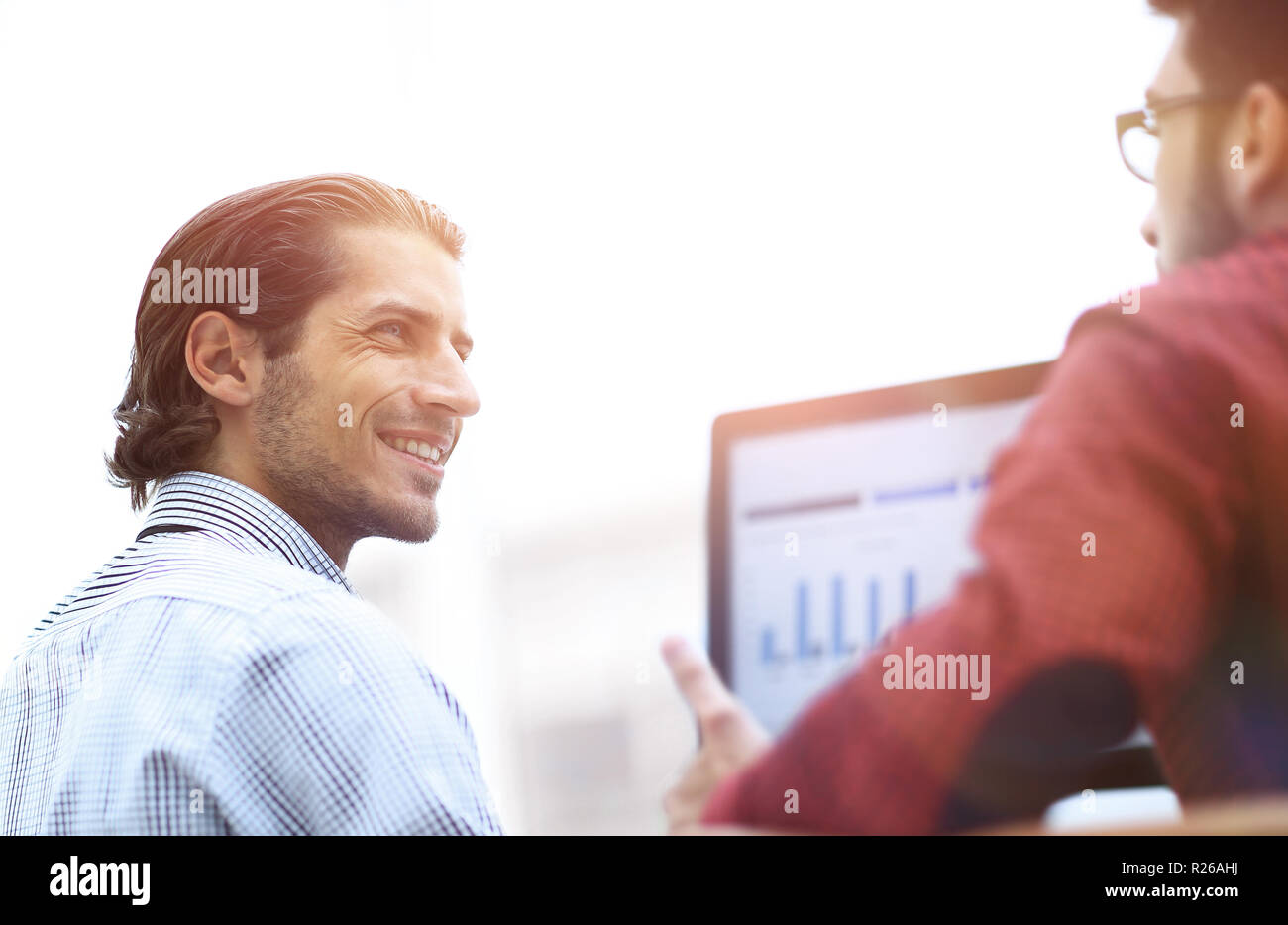 smiling employee talking with a colleague Stock Photo - Alamy