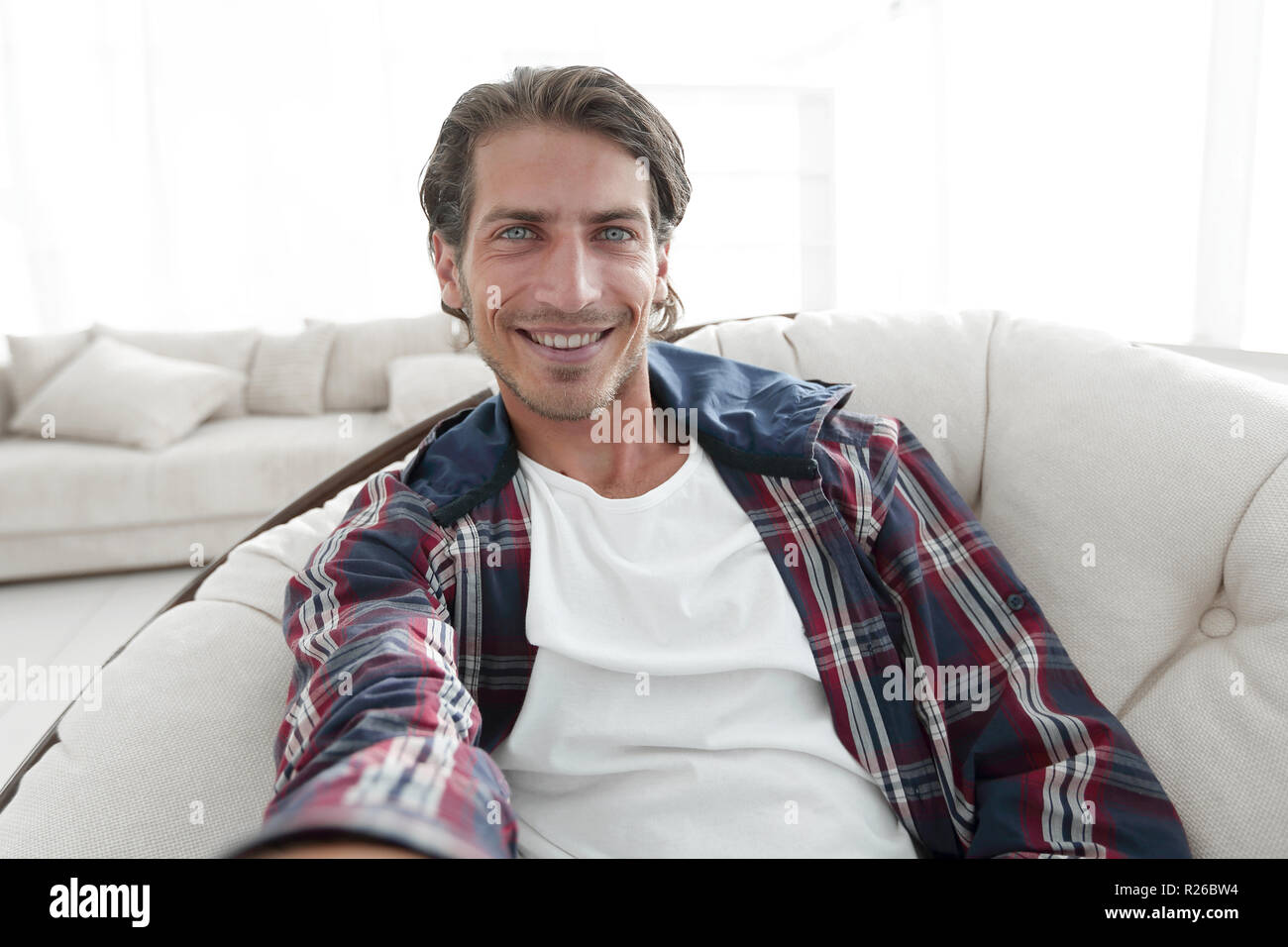 confident guy sitting in a chair and holding out his hand Stock Photo ...