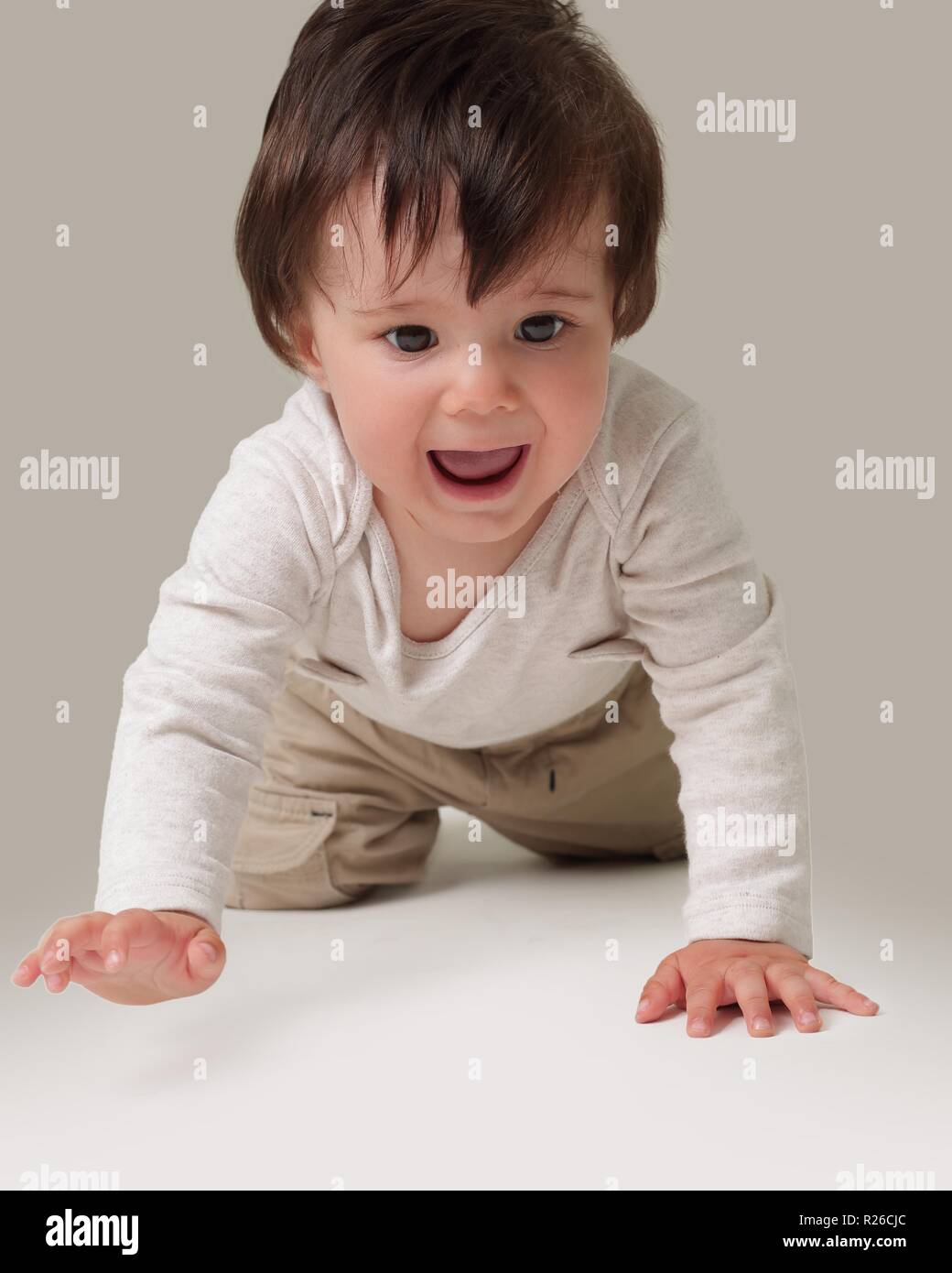 the baby learns to crawl isolated on white background Stock Photo - Alamy