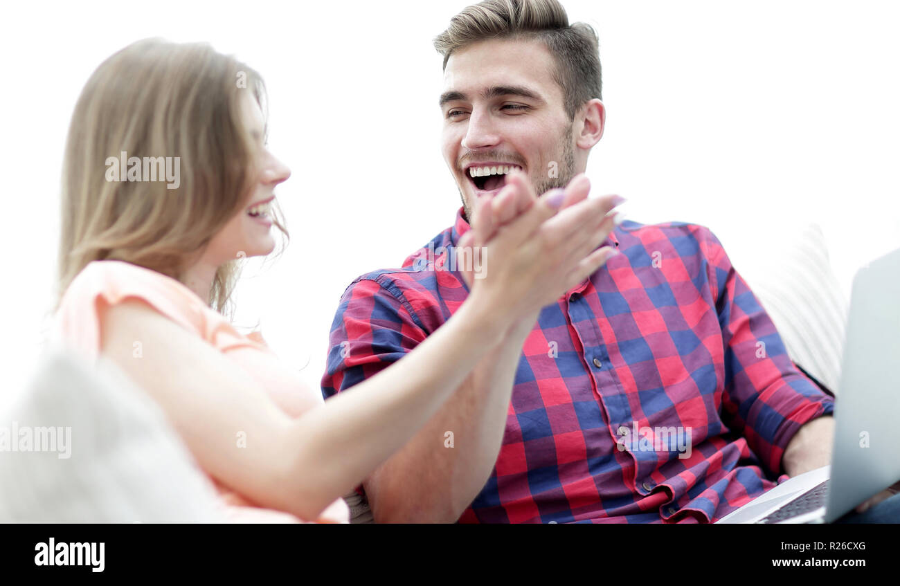 young man and his girlfriend cheering for their team while sitting on ...