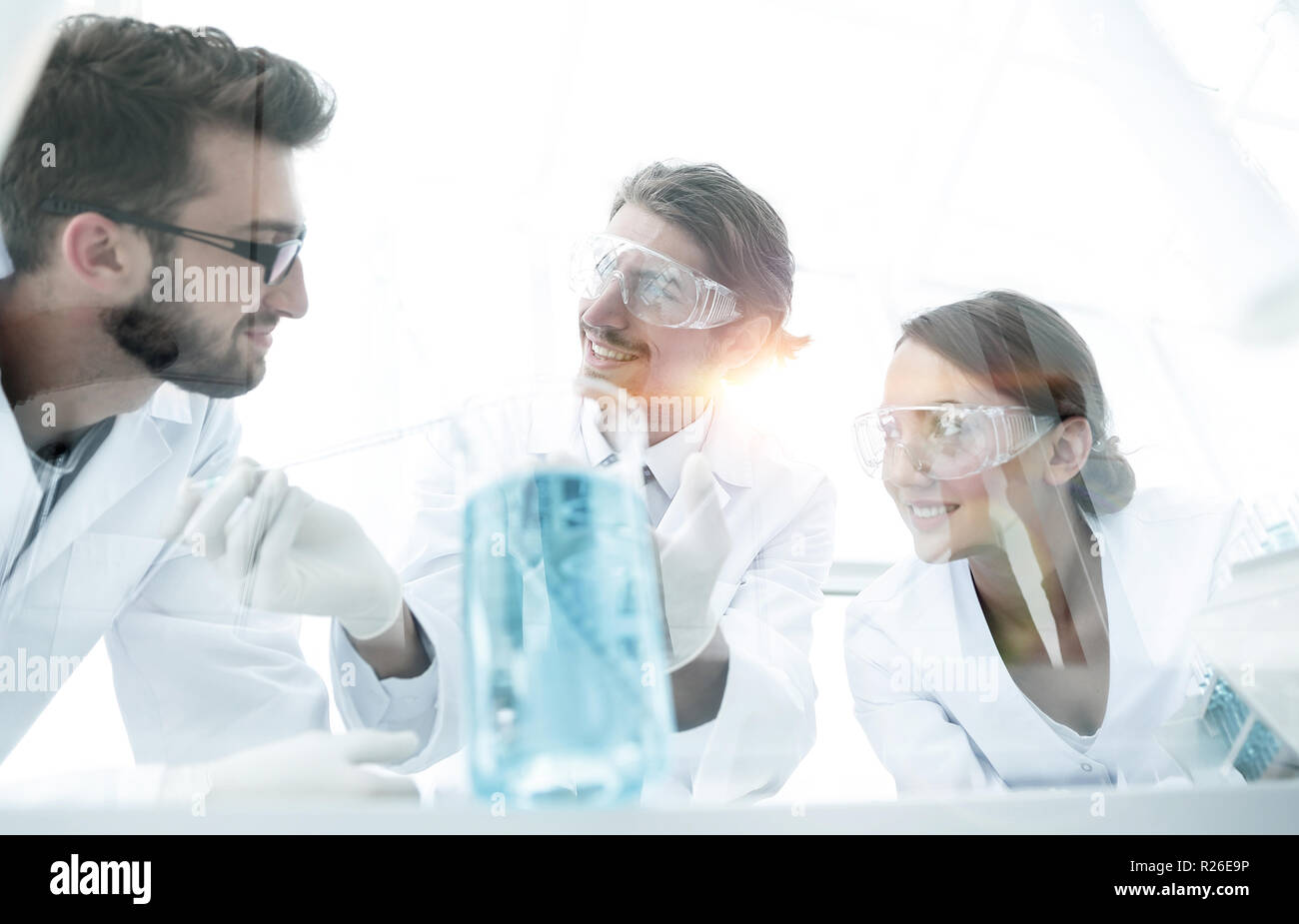 Group of scientists working on an experiment at the laboratory Stock Photo - Alamy