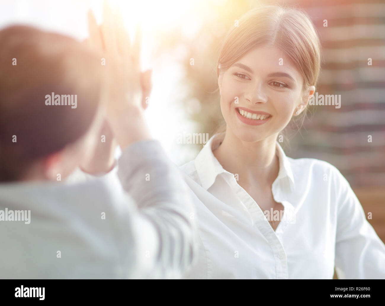 members of the business team giving each other a high five Stock Photo ...