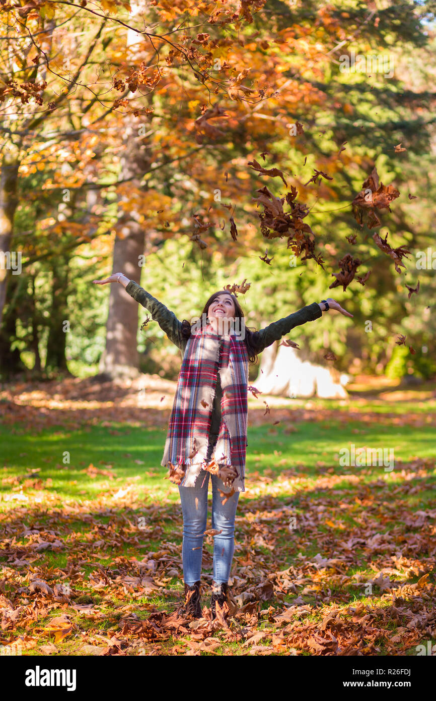 Woman throwing leaves in the air hi-res stock photography and images ...