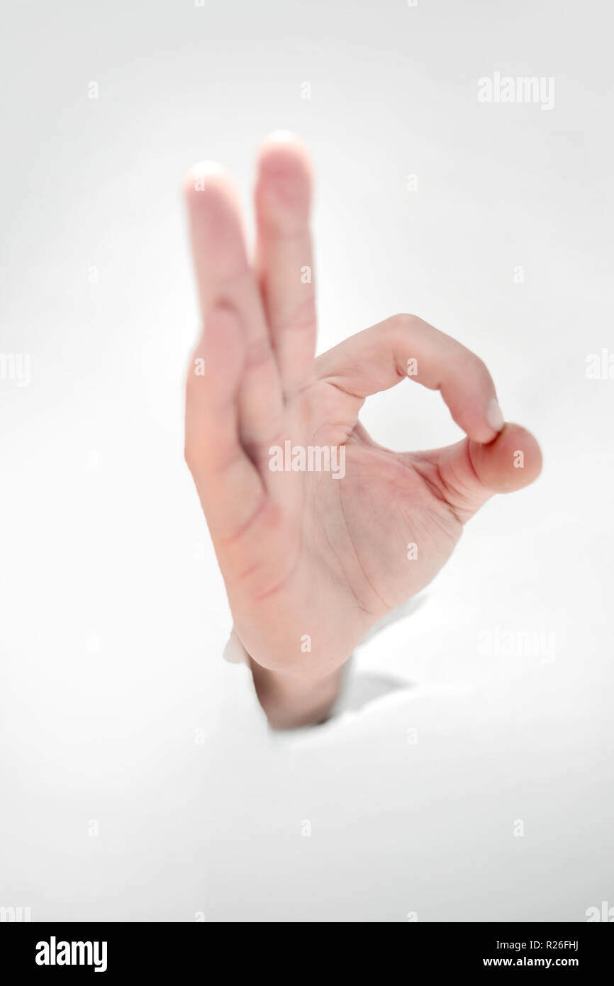 close up.male hand breaking through the paper wall and showing O Stock ...