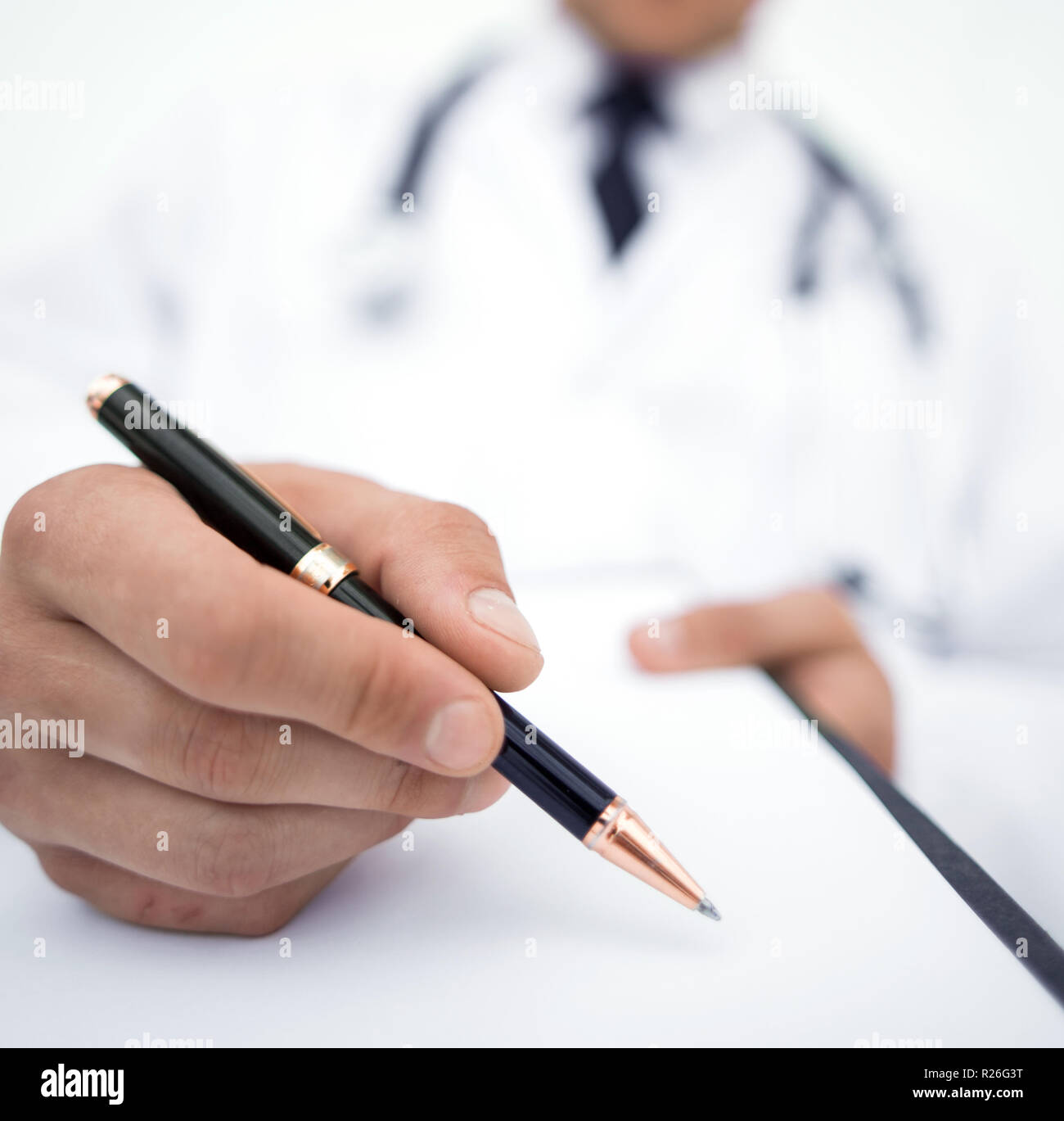 background image.the doctor signing the medical report Stock Photo - Alamy