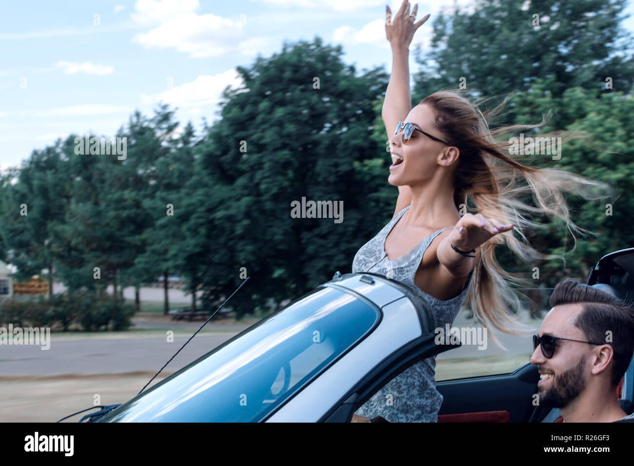 stylish girl enjoying a ride in a convertible car Stock Photo - Alamy