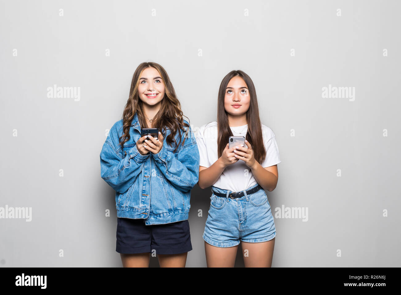 Portrait of two girls social network addiction on mobile phones ...