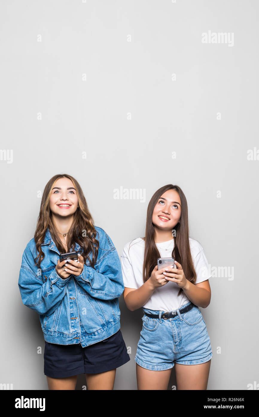 Portrait of two girls social network addiction on mobile phones ...