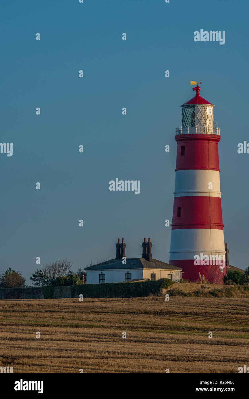Happisburgh lighthouse on the Norfolk coast with a blue sky and room ...