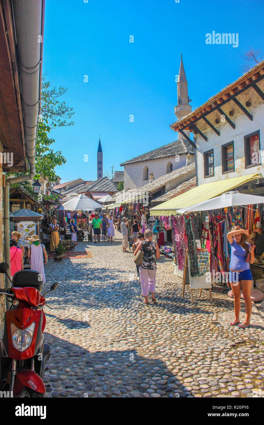August 2013, Mostar. Tourists relaxing & shopping in the cobbled ...