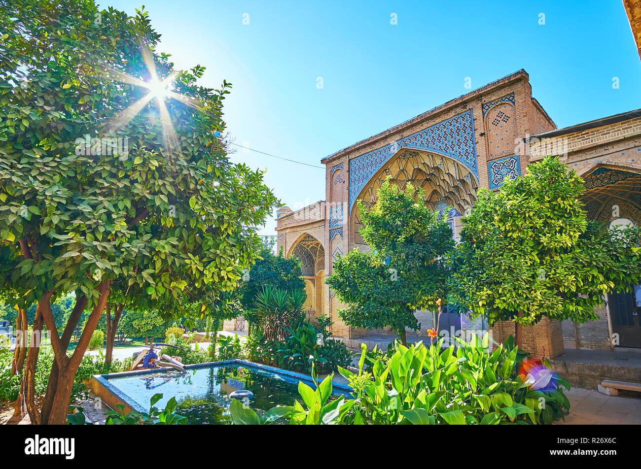 The shady court of Hafezieh with lush greenery, small pool and scenic ...