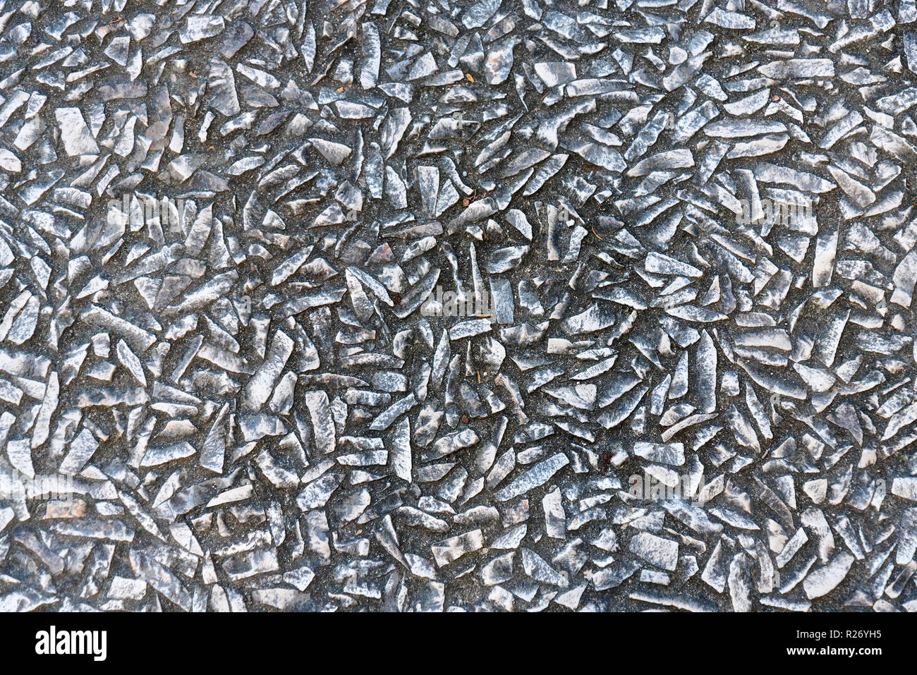 Texture of pointed white marble stones in the ground. Old worn stones ...