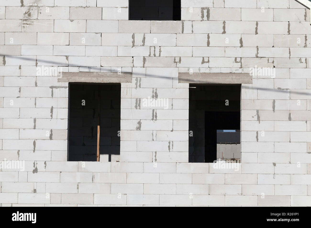 building a new house of white bricks in the countryside, closeup of the ...
