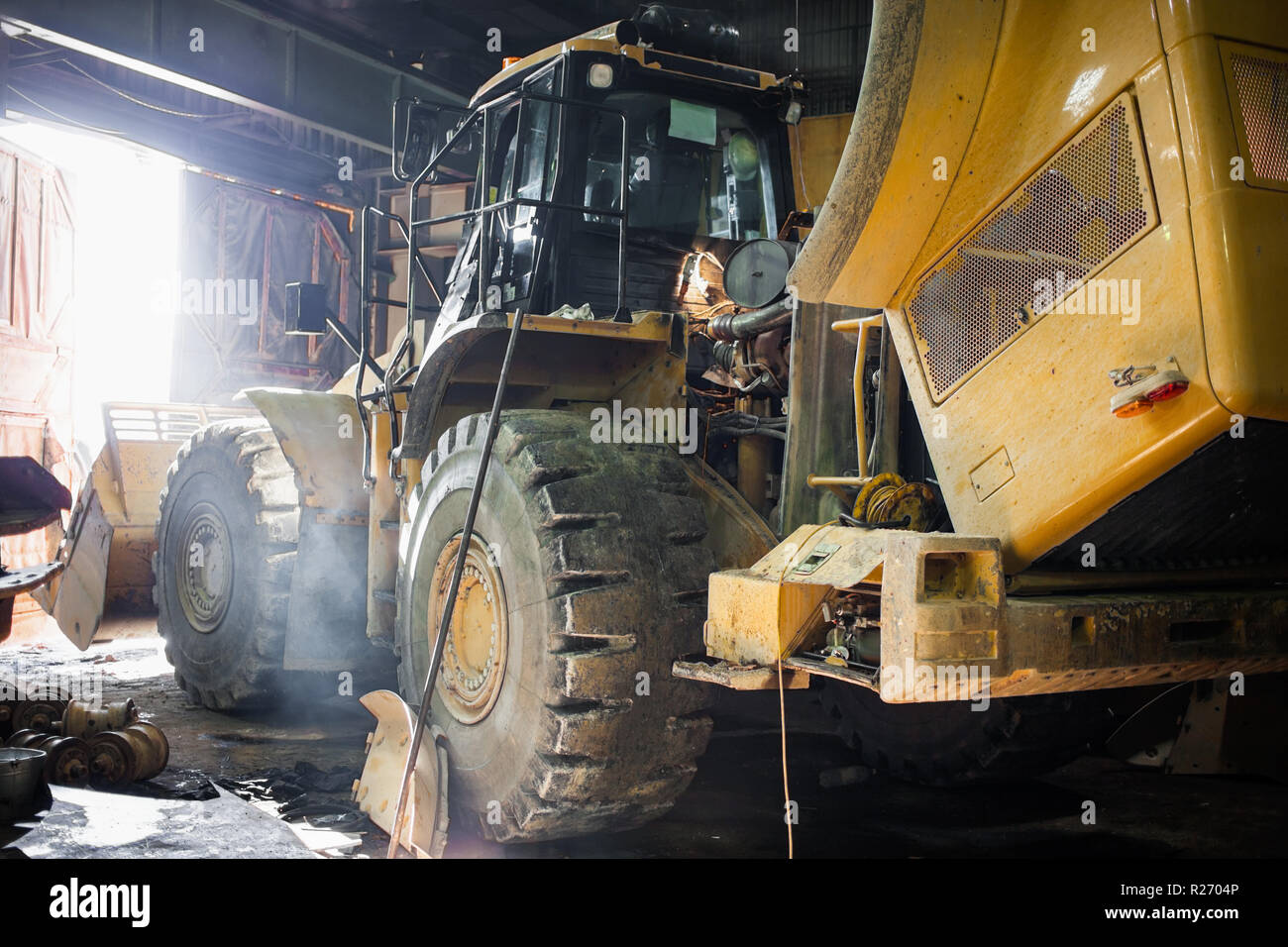 Heavy wheel loader being repaired in garage Stock Photo - Alamy