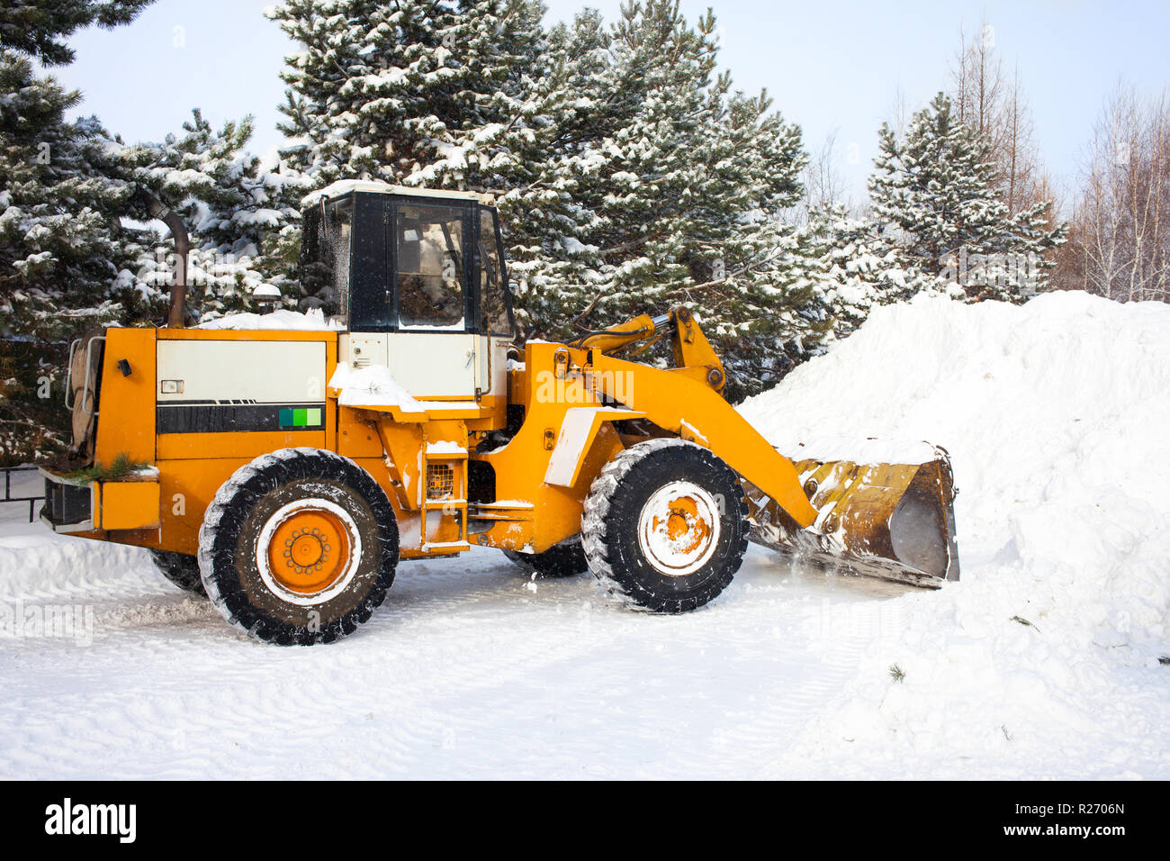 Wheel loader is cleaning a road from snow in Khabarovsk, Russia Stock ...