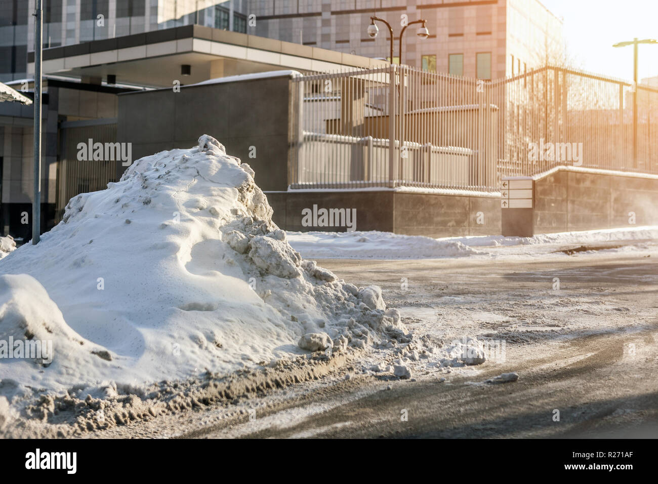 Big snowdrift on city street after heavy snowfall in winter. Heap of ...