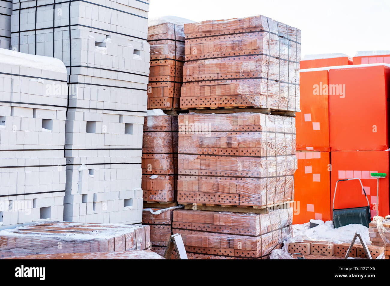 Stock pallets of red bricks wrapped in stretch film at wholesale outdoor market ot store ...