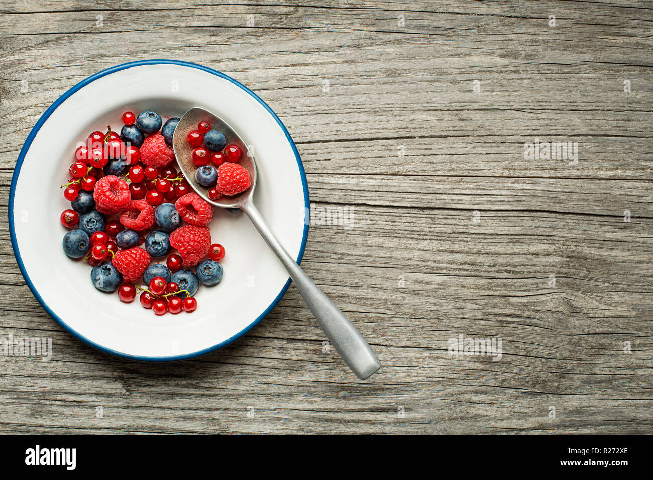 Healthy snack with fresh berries in a bowl on wooden background Stock ...