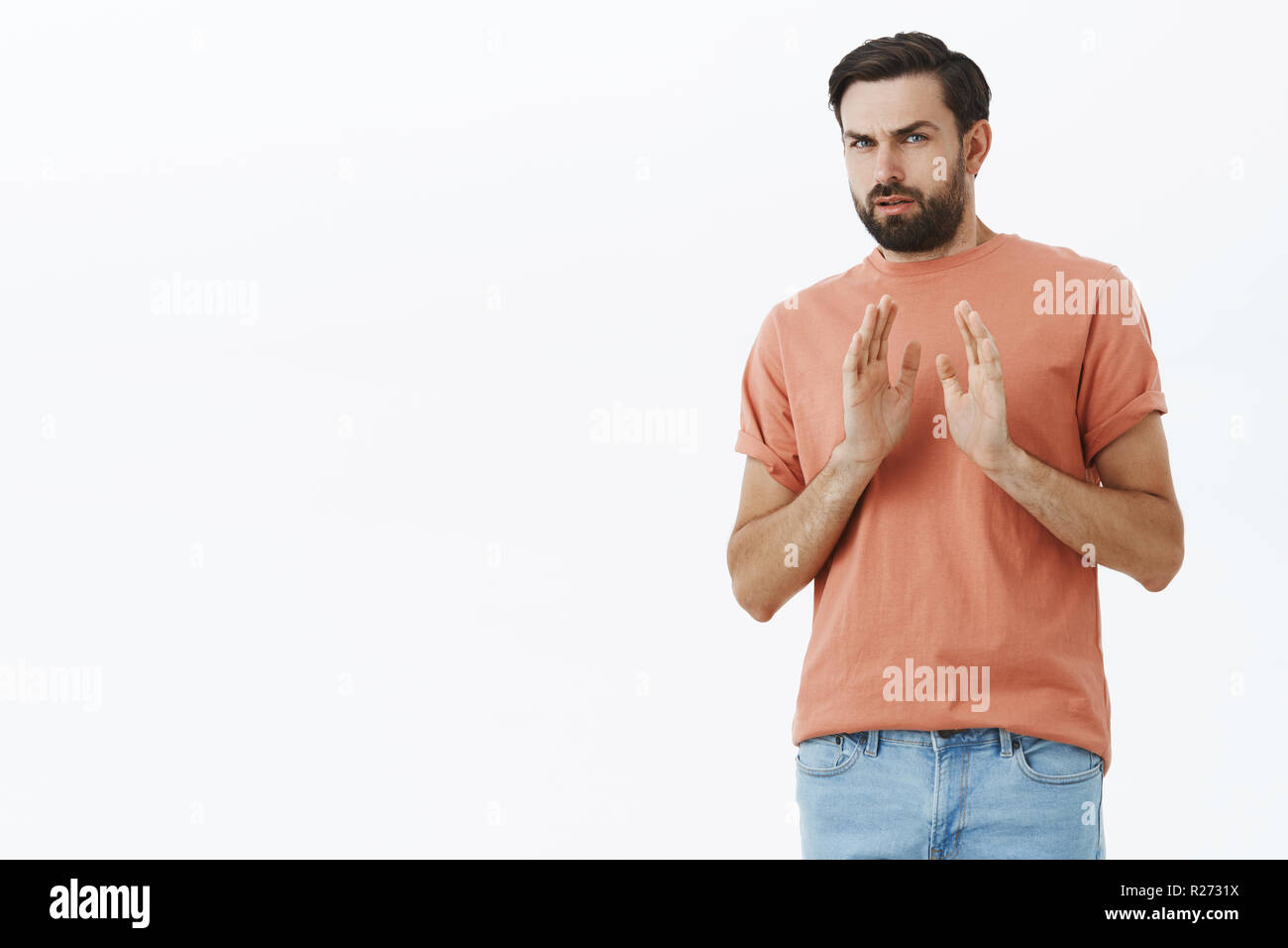 Guy refusing try meal being stuffed, holding hands near chest in ...