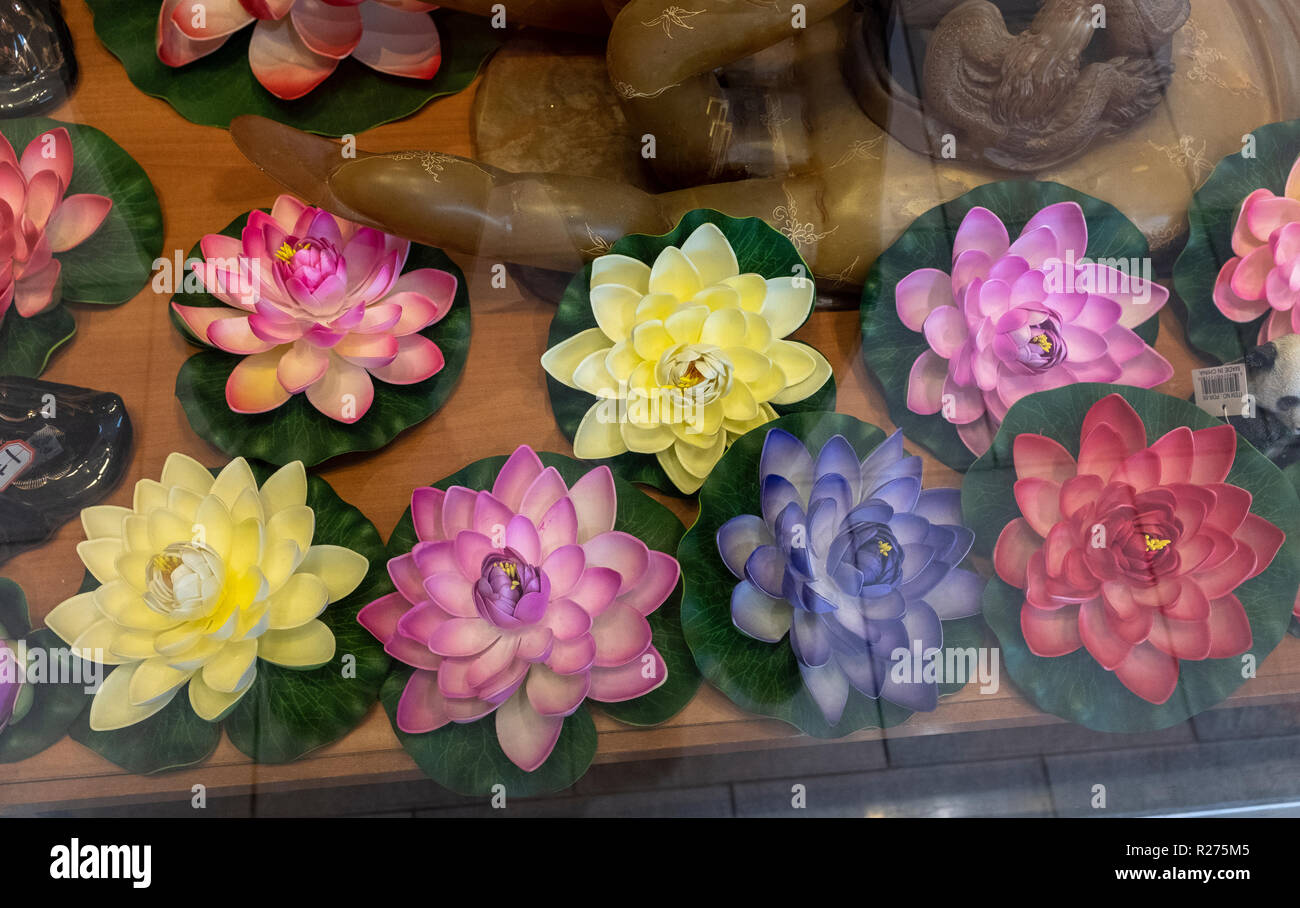 Chinese plastic lotus flowers in window display Stock Photo - Alamy