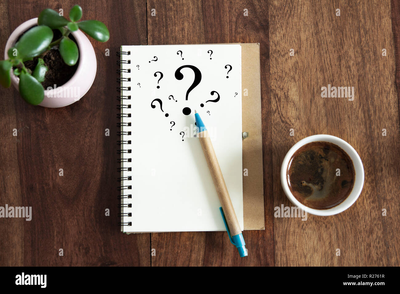 question mark symbols in notebook laying on office desk. flat lay view ...