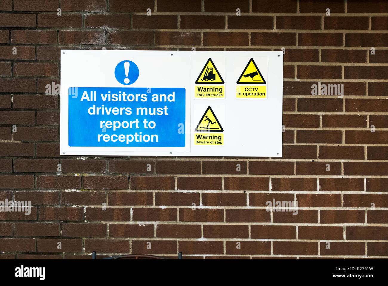 Visitors and drivers report to reception sign at work Stock Photo - Alamy