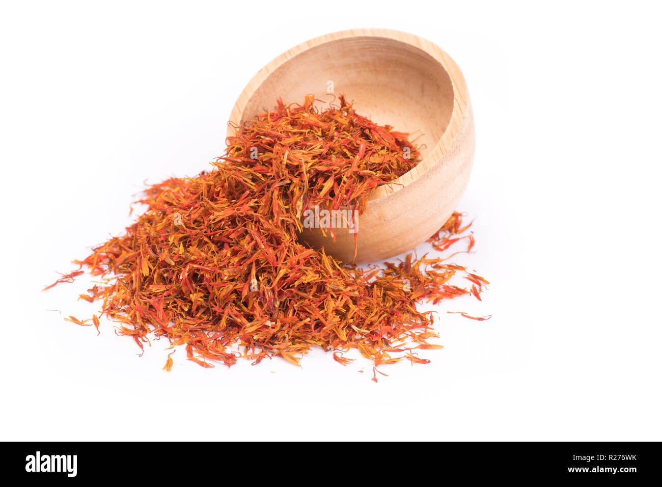 Dried safflower in wooden bowl isolated on white background Stock Photo ...