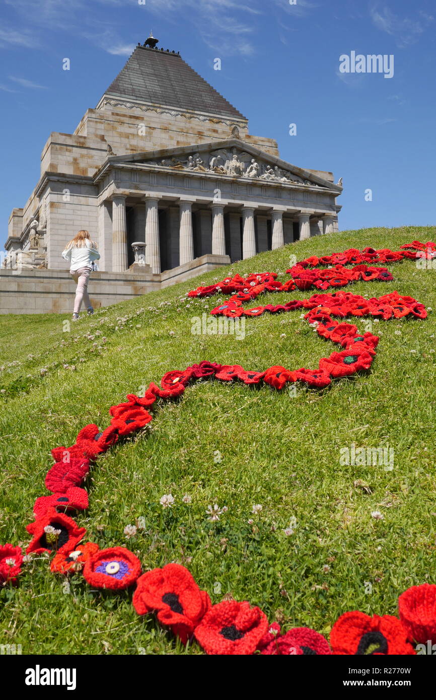 Vertical image of bright red yarn poppies laid out in beautiful pattern ...