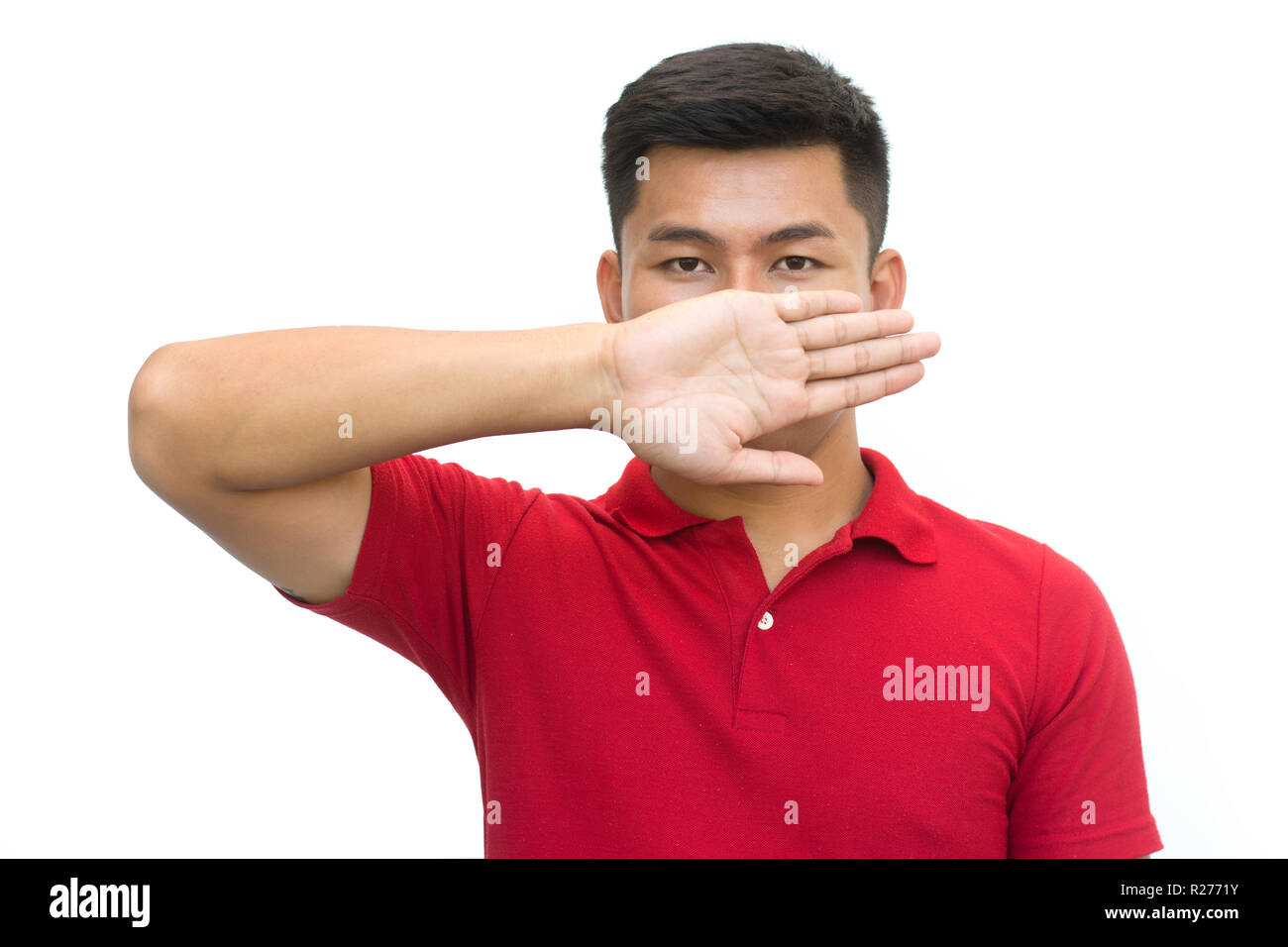 Scared young man covering mouth with hand isolated on white background ...