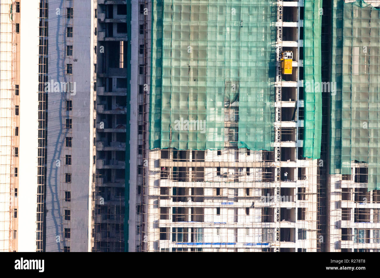 Aerial shot of under construction building with safety nets Stock Photo ...