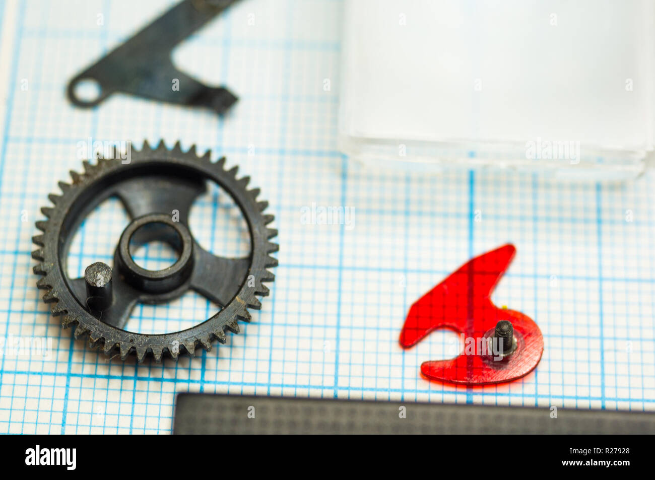 parts are completely disassembled old retro film SLR camera on graph ...