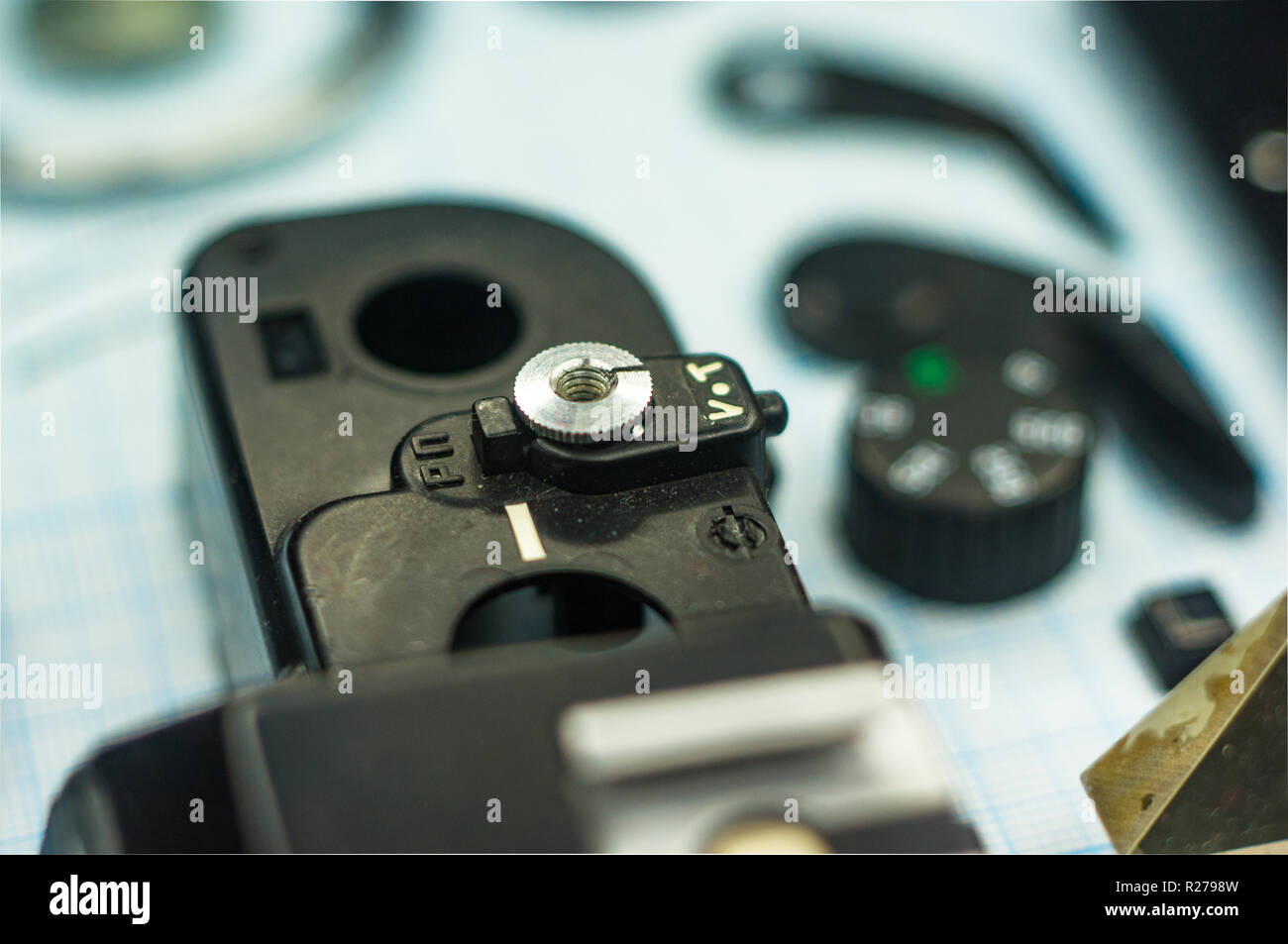 parts are completely disassembled old retro film SLR camera on graph ...
