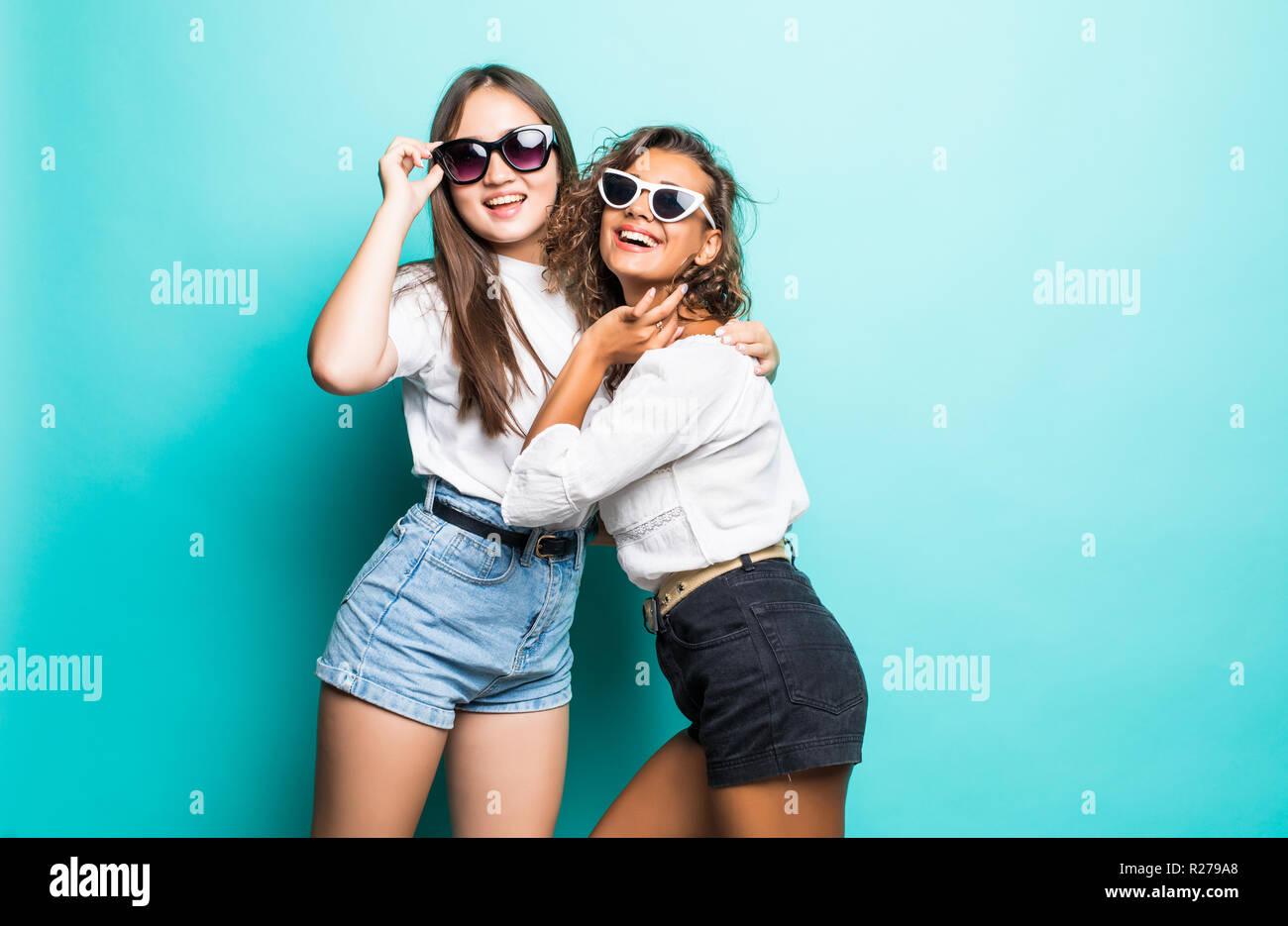 Friends forever. Two cute lovely girl friends in sunglasses posing with ...