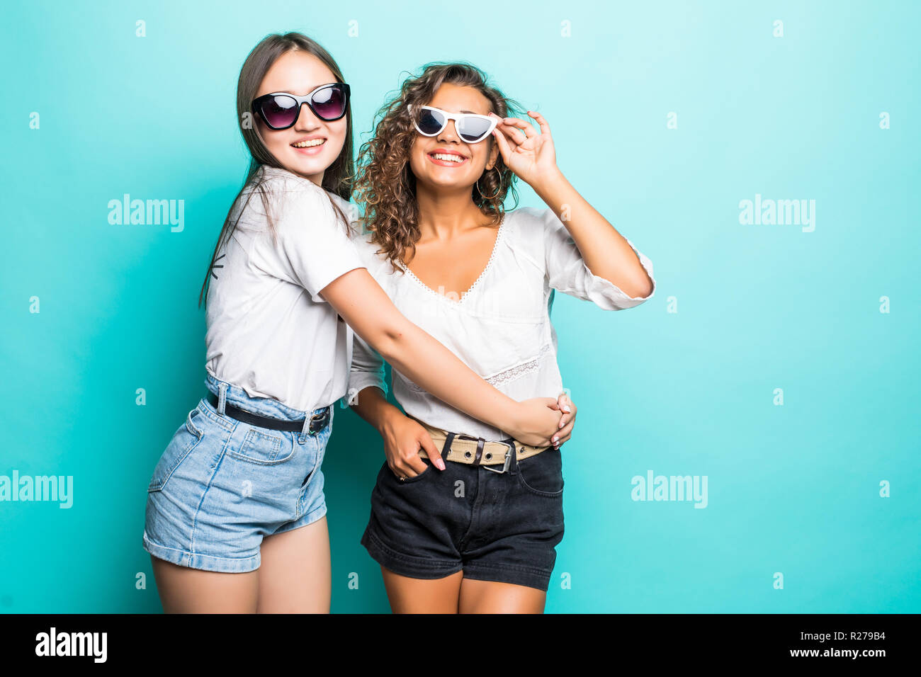 Friends forever. Two cute lovely girl friends in sunglasses posing with ...