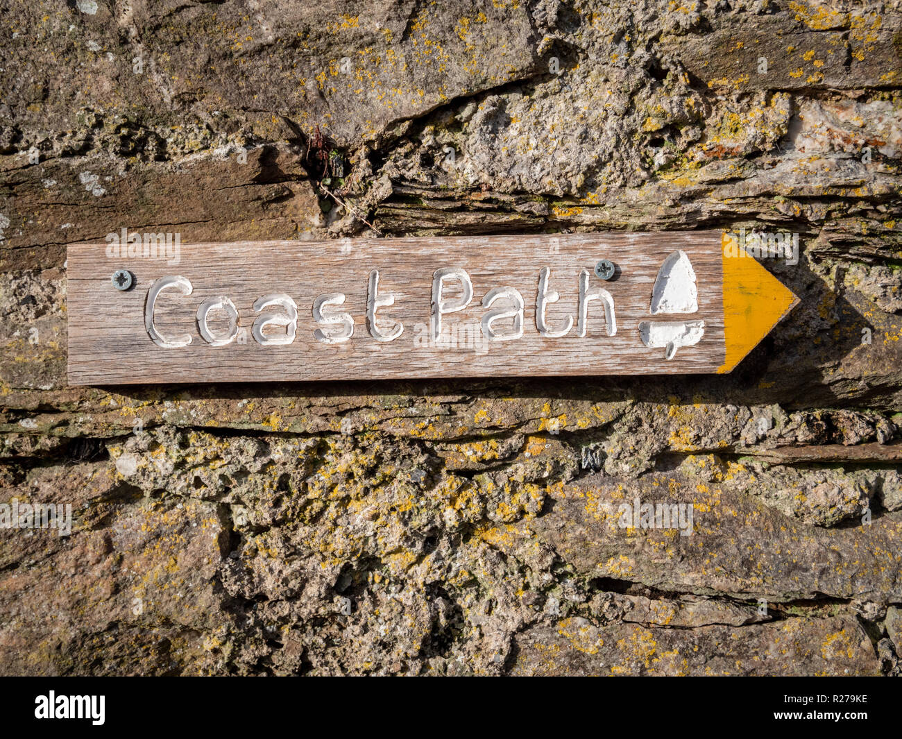 A wooden directions footpath sign for the coastal path in Combe martin ...