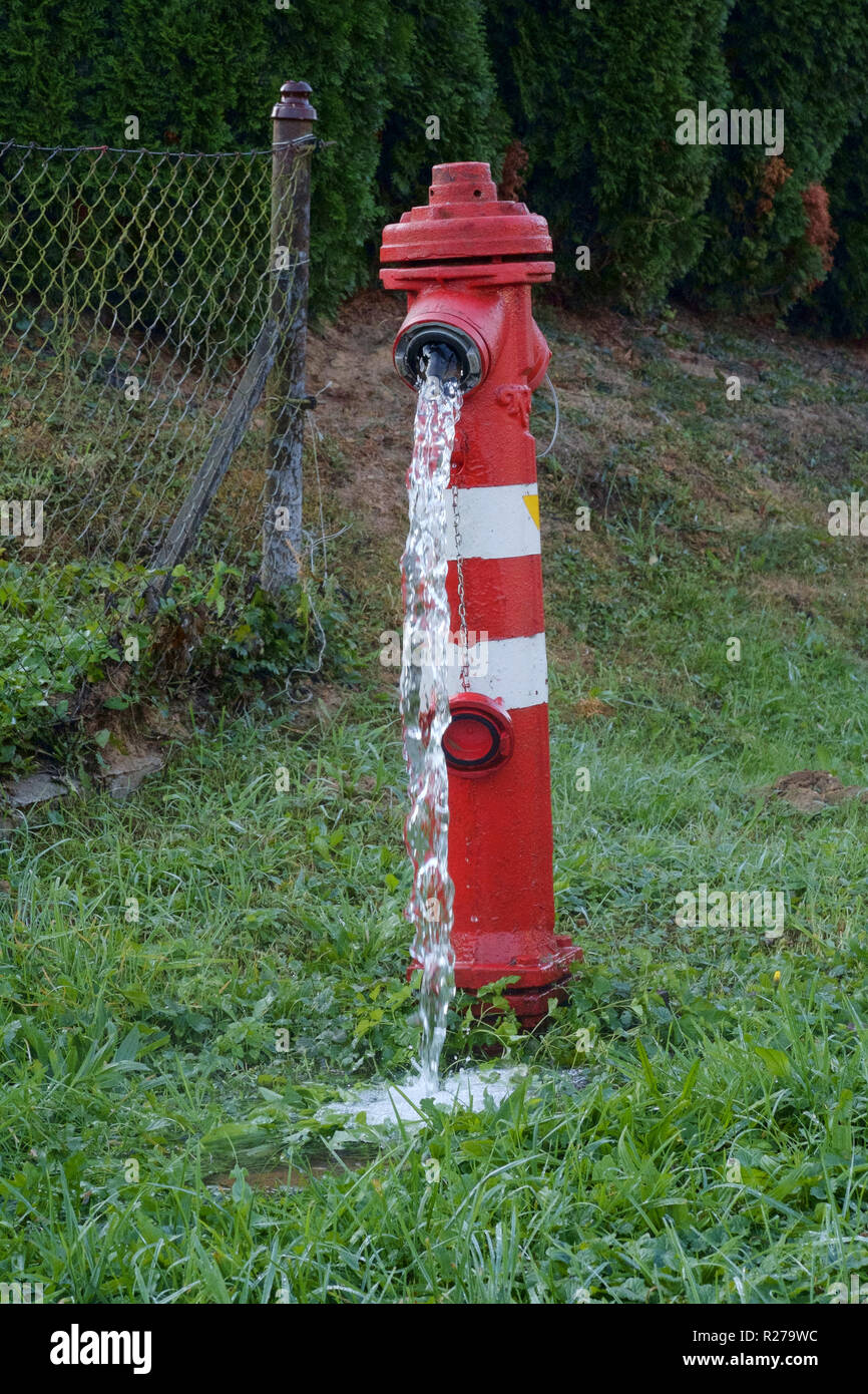 roadside hydrant pouring water into a ditch in a rural village zala ...