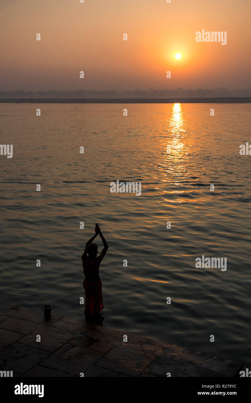 Morning ritual at sunrise along the riverbank of the Ganges in Varanasi ...