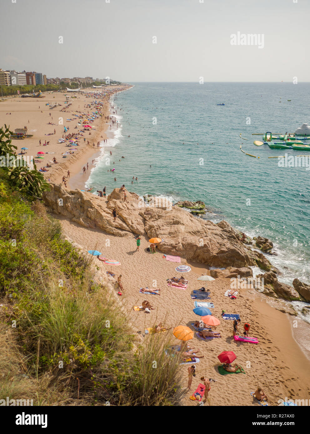 People at beach in Calella city. Spain Stock Photo - Alamy