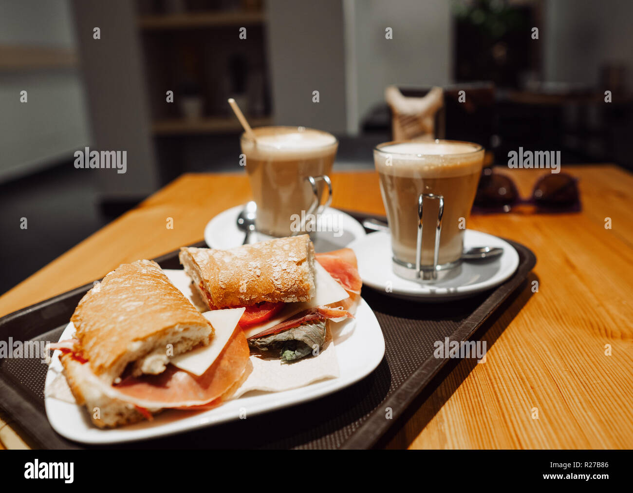 breakfest snack - coffee latte and bocadillo sandwich on table in one ...