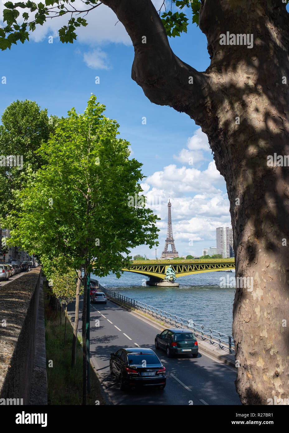 Cars moving on street with Eiffel Tower and River Seine in background ...