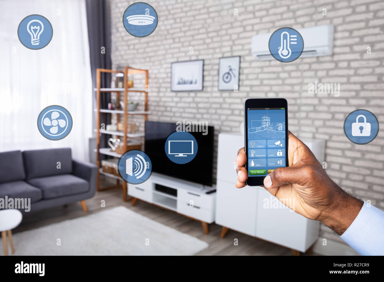 Man's Hand Using Home Control System On Cellphone With Various Icons ...