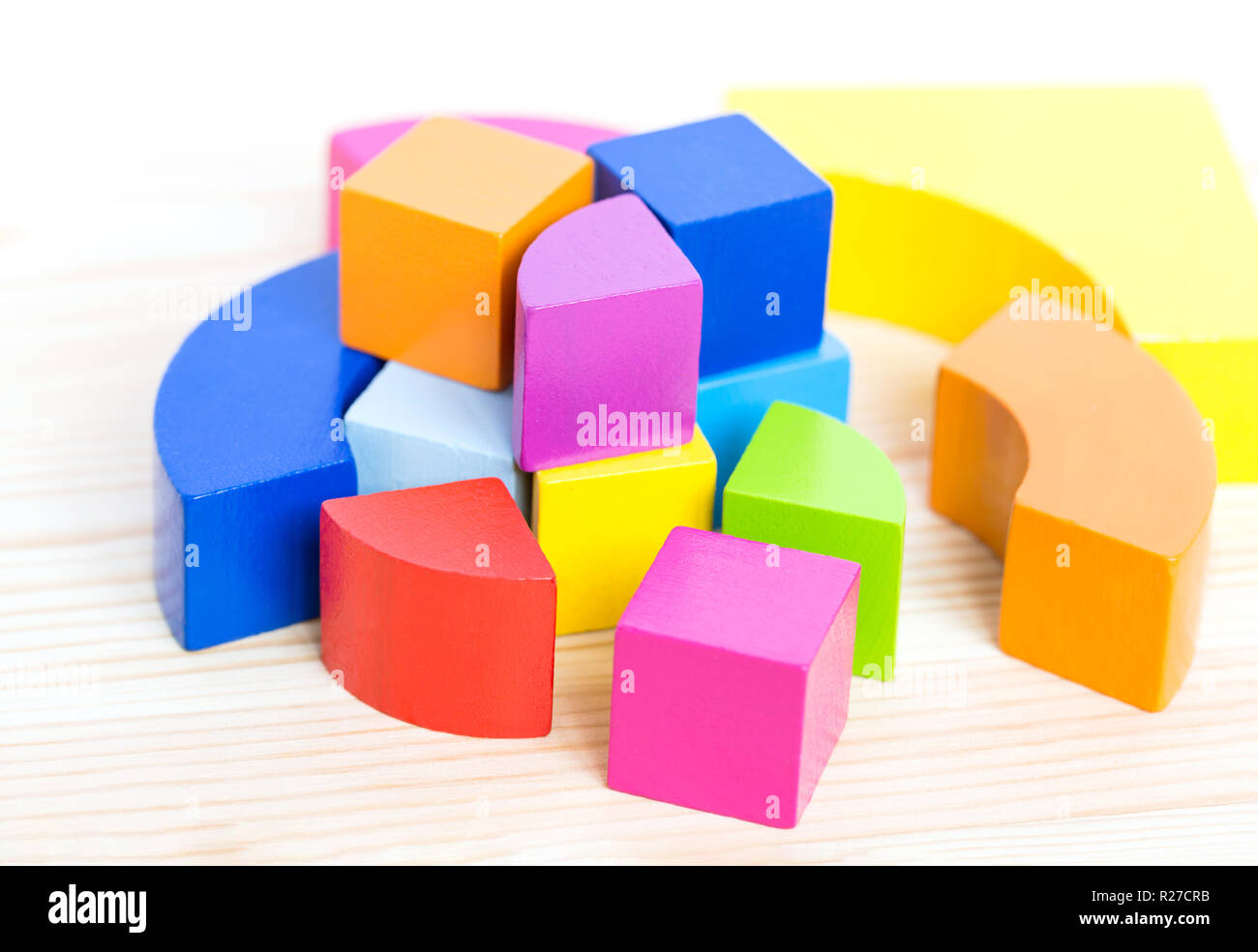 Colored wooden blocks, cubes, build on a light wooden background Stock ...