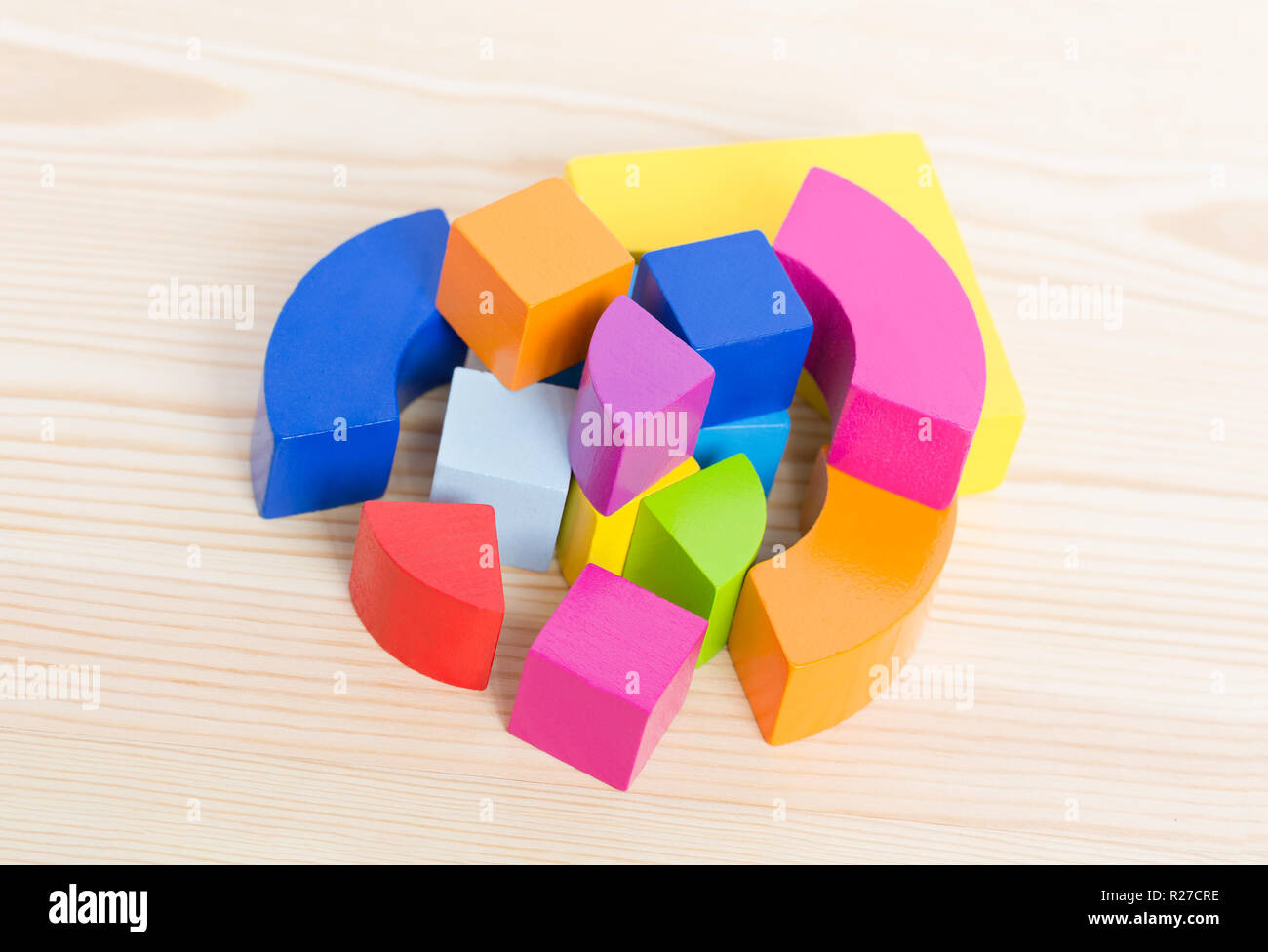 Colored wooden blocks, cubes, build on a light wooden background Stock ...