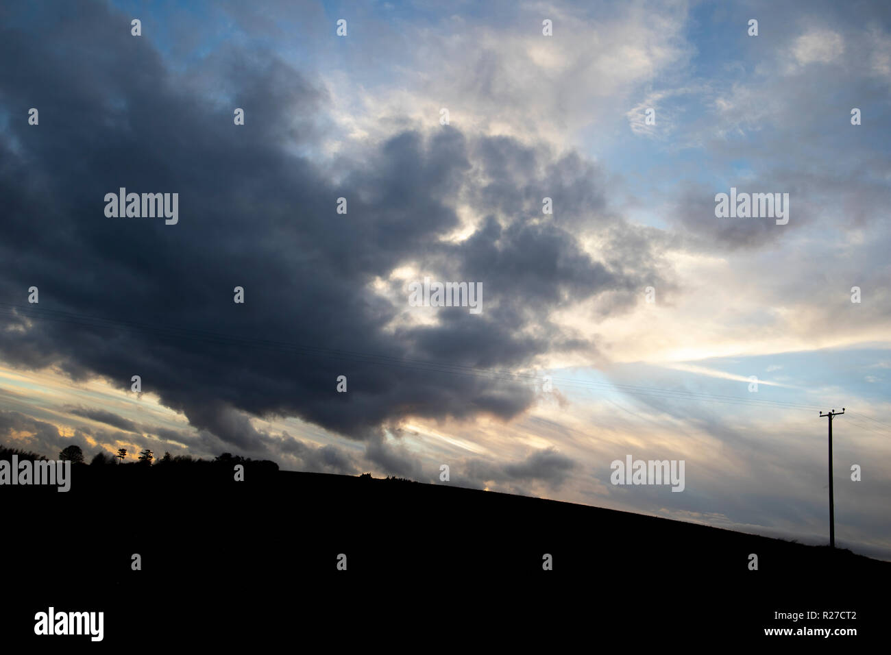 Dusk over farmland in the rural county of Hampshire with tree lined ...