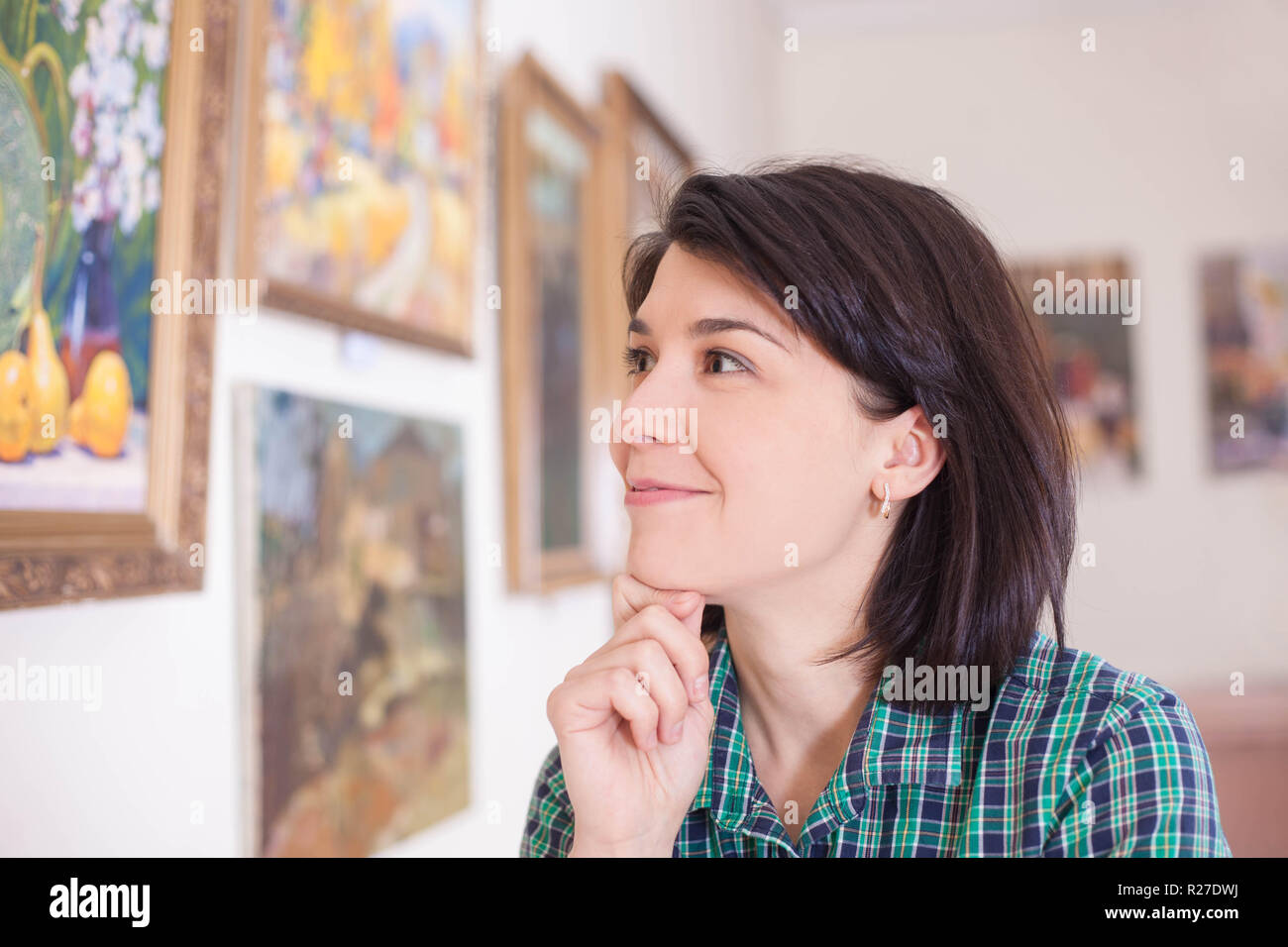 Person in a gallery looking at painting hi-res stock photography and ...