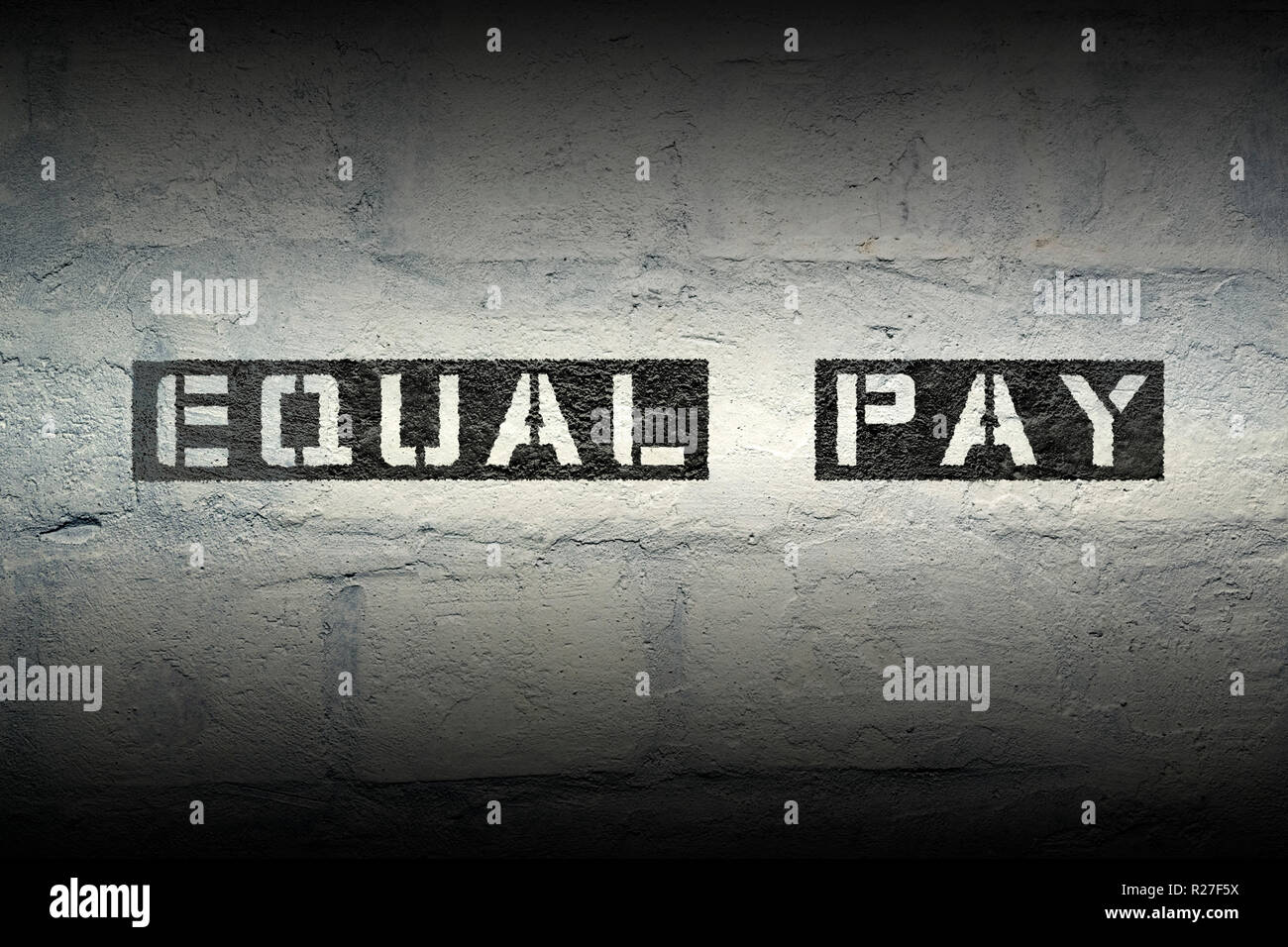 equal pay stencil print on the grunge white brick wall Stock Photo - Alamy