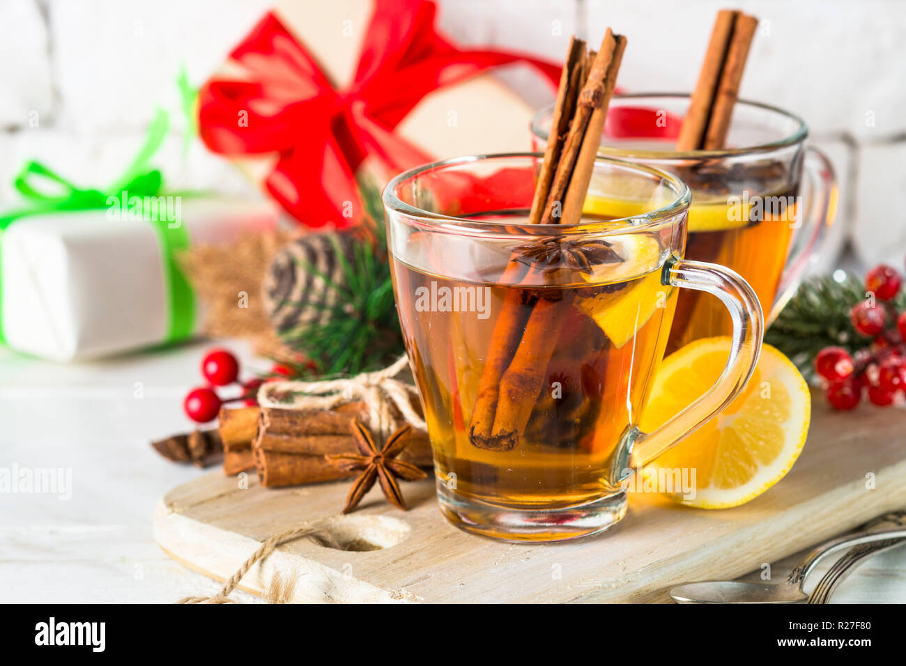 Christmas hot tea with lemon, spices and decorations Stock Photo - Alamy